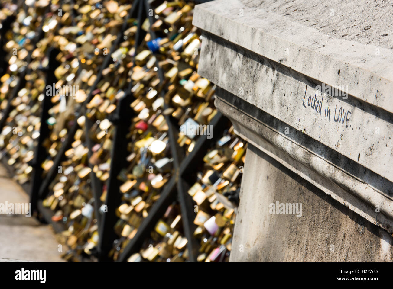The phrase 'locked in love' is written in graffiti on the pont neuf and ...