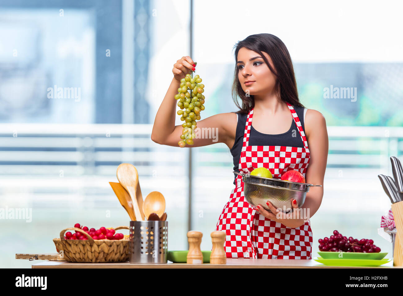 Young cook with fruits in the kitchen Stock Photo - Alamy