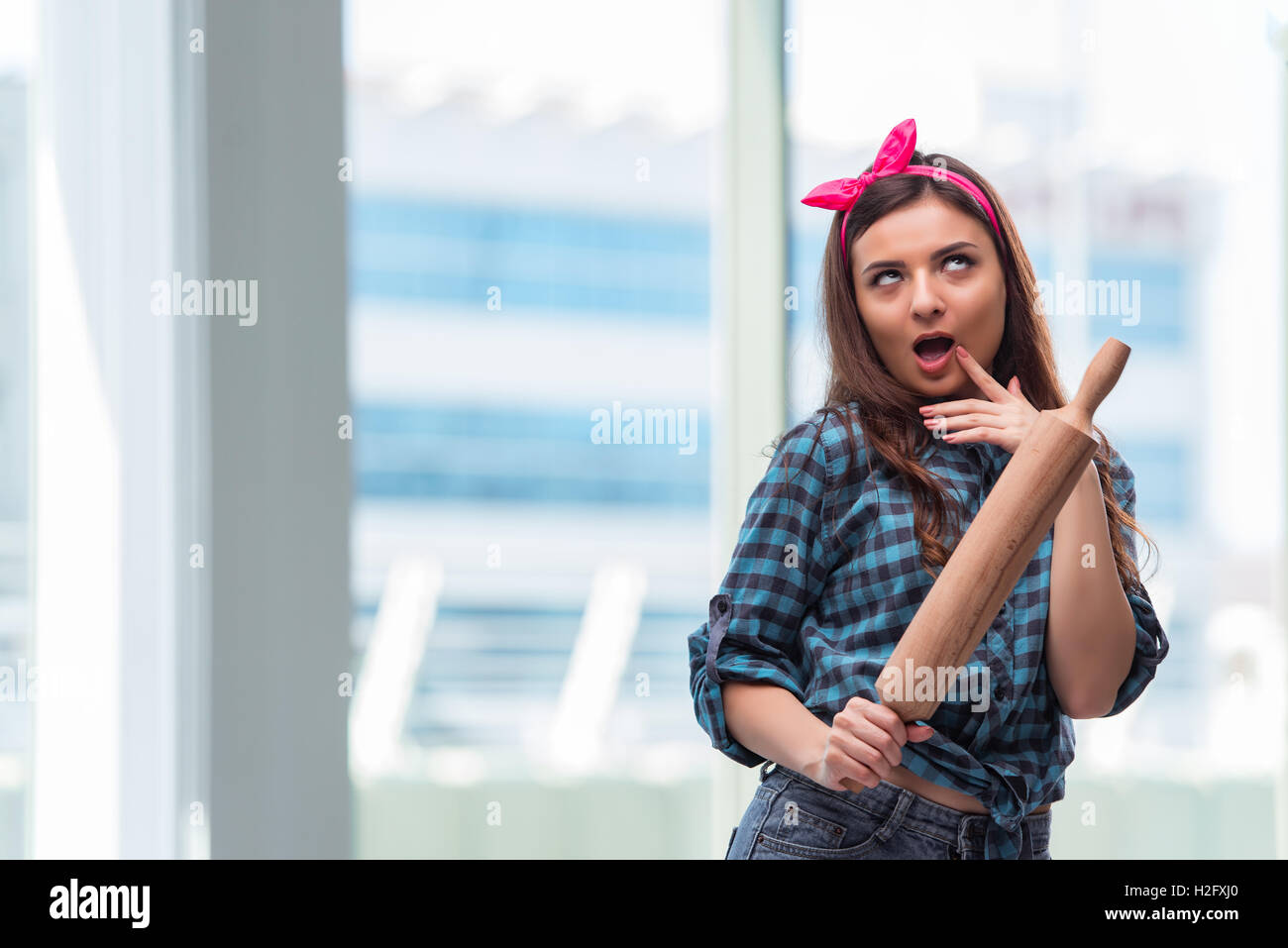 Woman with rolling pin in the kitchen Stock Photo - Alamy