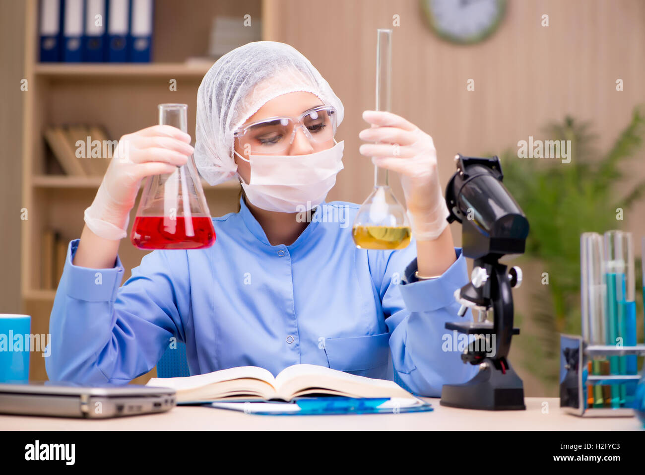 Lab chemist working with microscope and tubes Stock Photo - Alamy