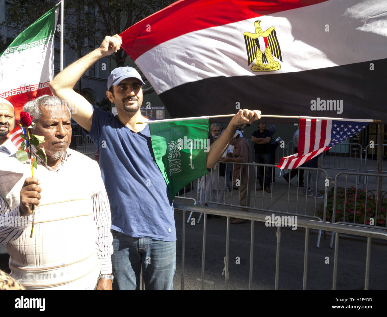 Men carrying US flag and flags of Egypt and Saudi Arabia at American ...