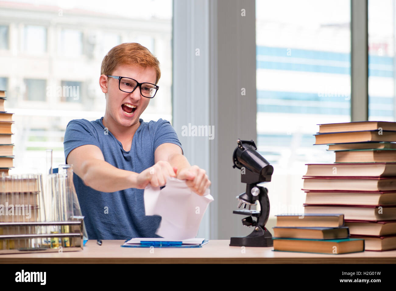 Young student tired and exhausted preparing for chemistry exam Stock ...