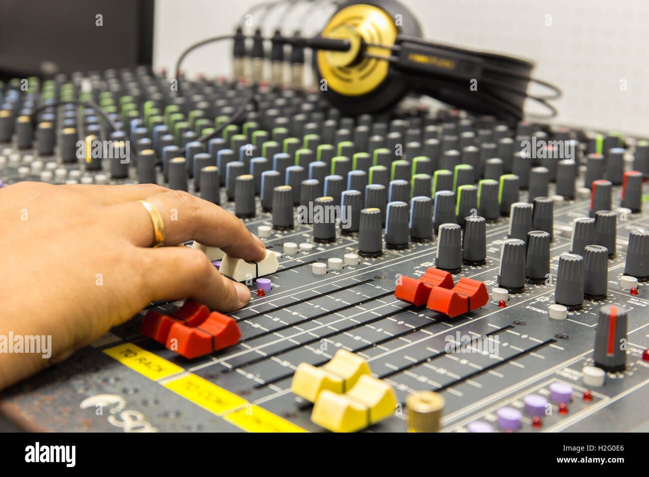 Hand adjusting audio mixer Stock Photo - Alamy