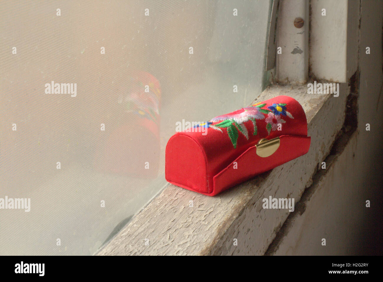 red jewelry box near window Stock Photo - Alamy