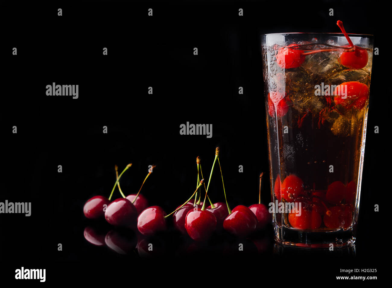 Refreshing cold cherry cola isolated on a black background Stock Photo ...