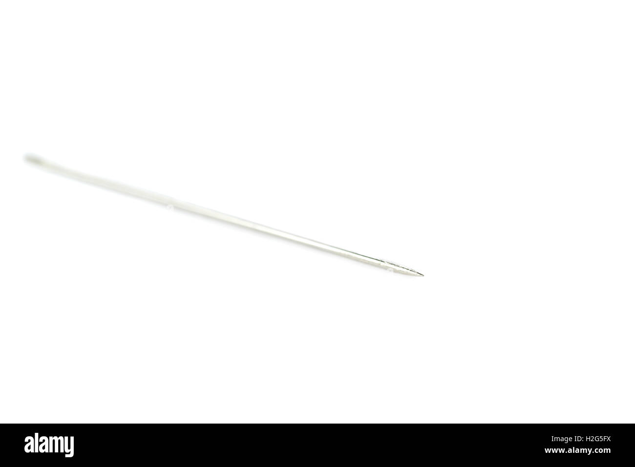 Small needle isolated over the white background Stock Photo - Alamy