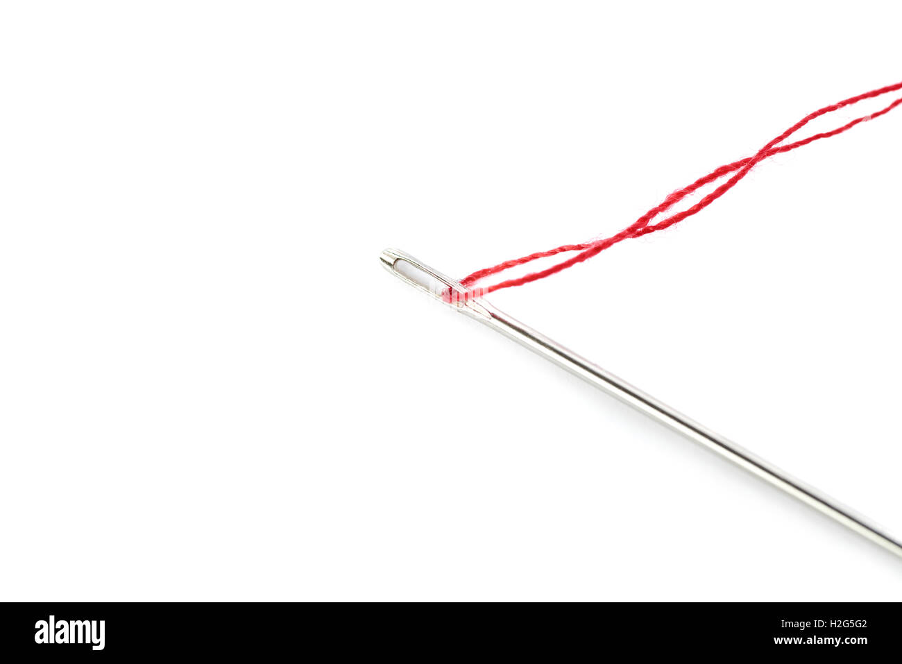 Small needle with thread isolated over the white background Stock Photo ...