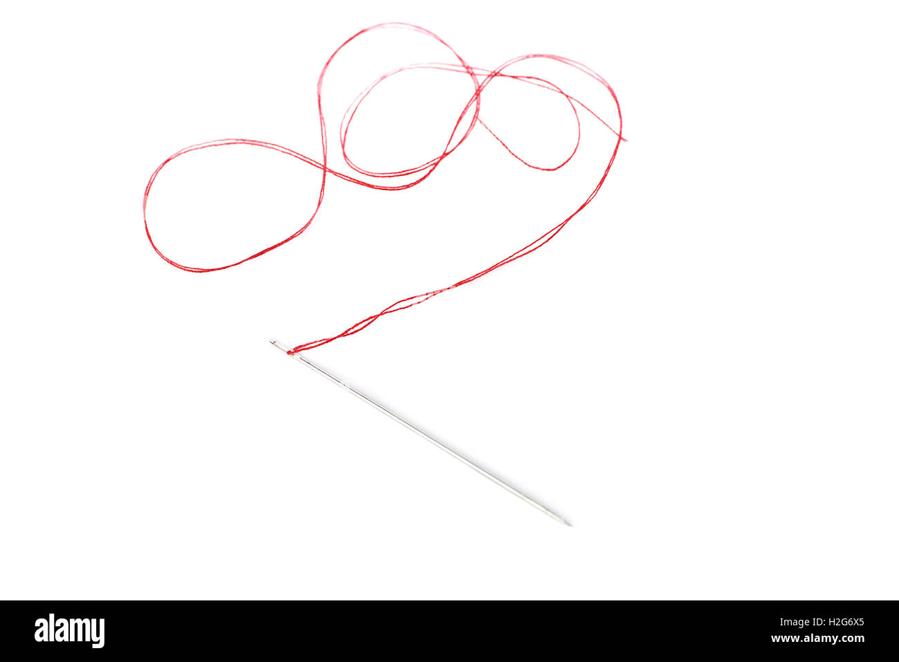 Small needle with thread isolated over the white background Stock Photo ...