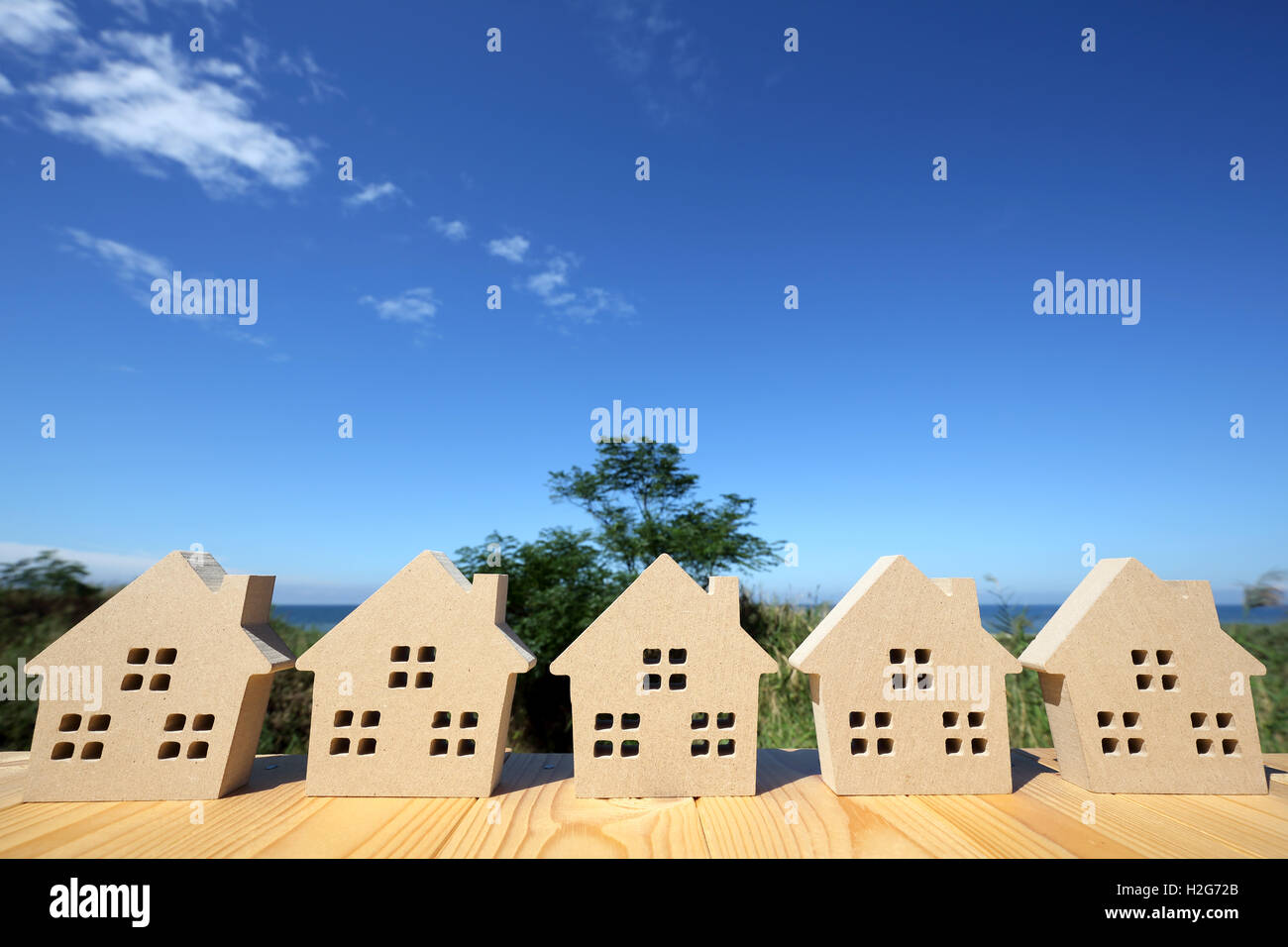 wooden toy house against clear blue sky background Stock Photo - Alamy