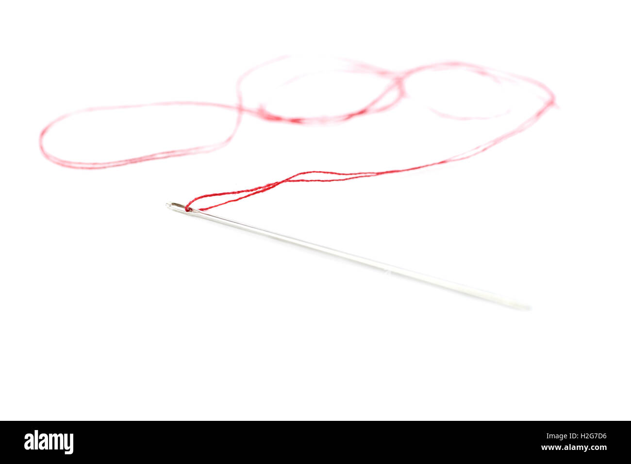 Small needle with thread isolated over the white background Stock Photo ...