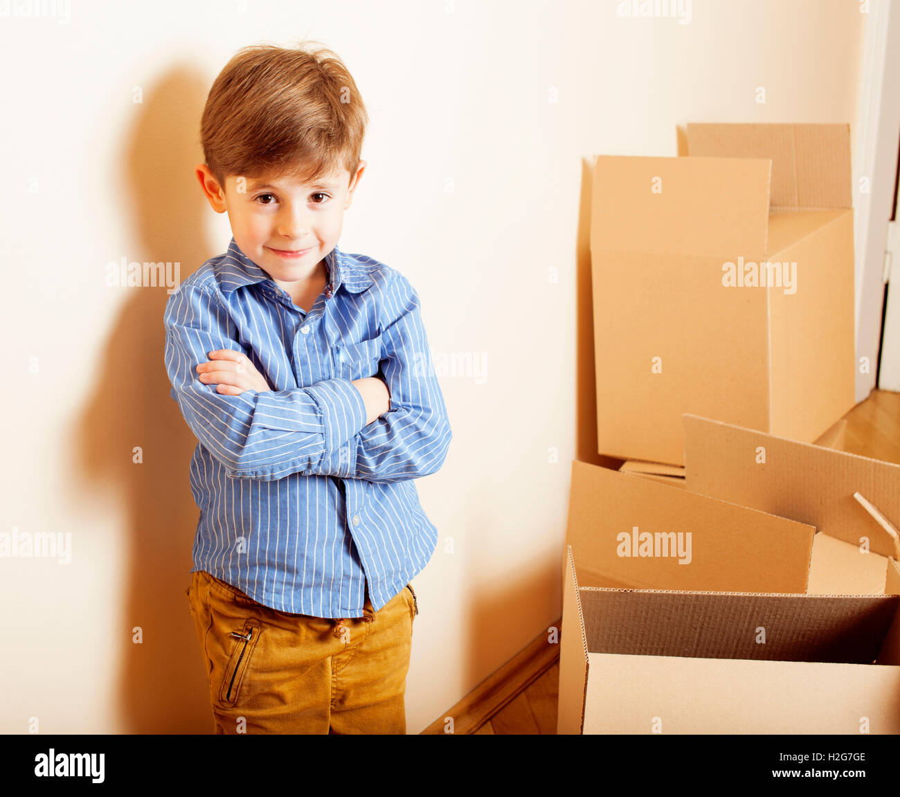 little cute boy in empty room, remoove to new house. home alone among ...