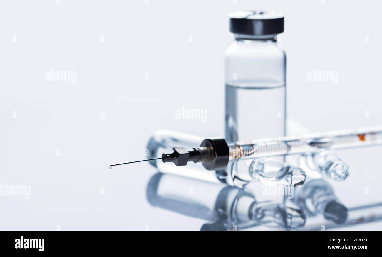 medicament in a glass vial and syringe closeup Stock Photo - Alamy