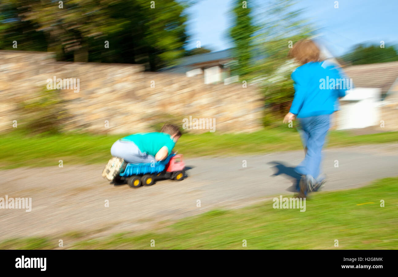 Kids playing downhill hi-res stock photography and images - Alamy