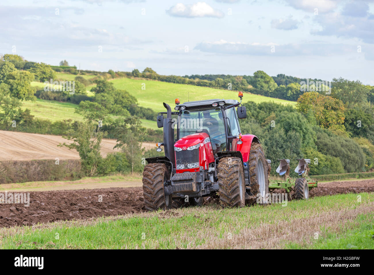 Farm tractor ploughing, England, UK Stock Photo - Alamy