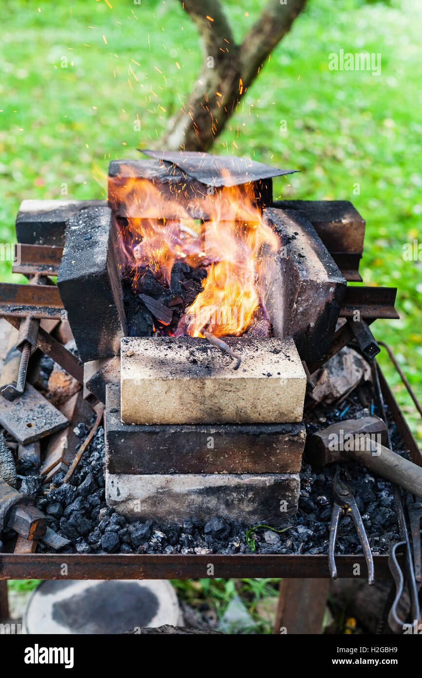 steel rod is heated in rural forging furnace in burning coals Stock ...