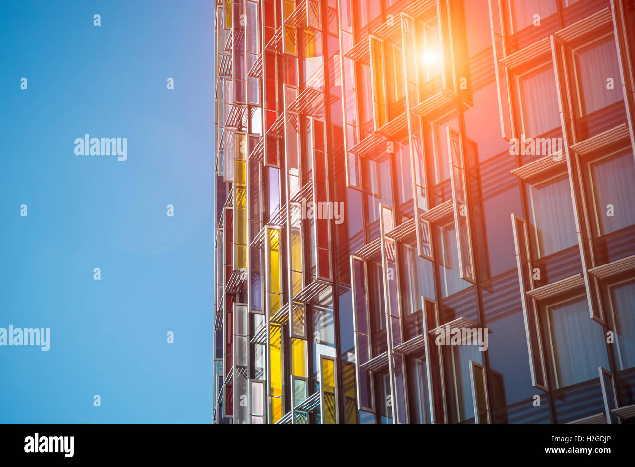 sun reflecting off the glass of a modern office building Stock Photo ...