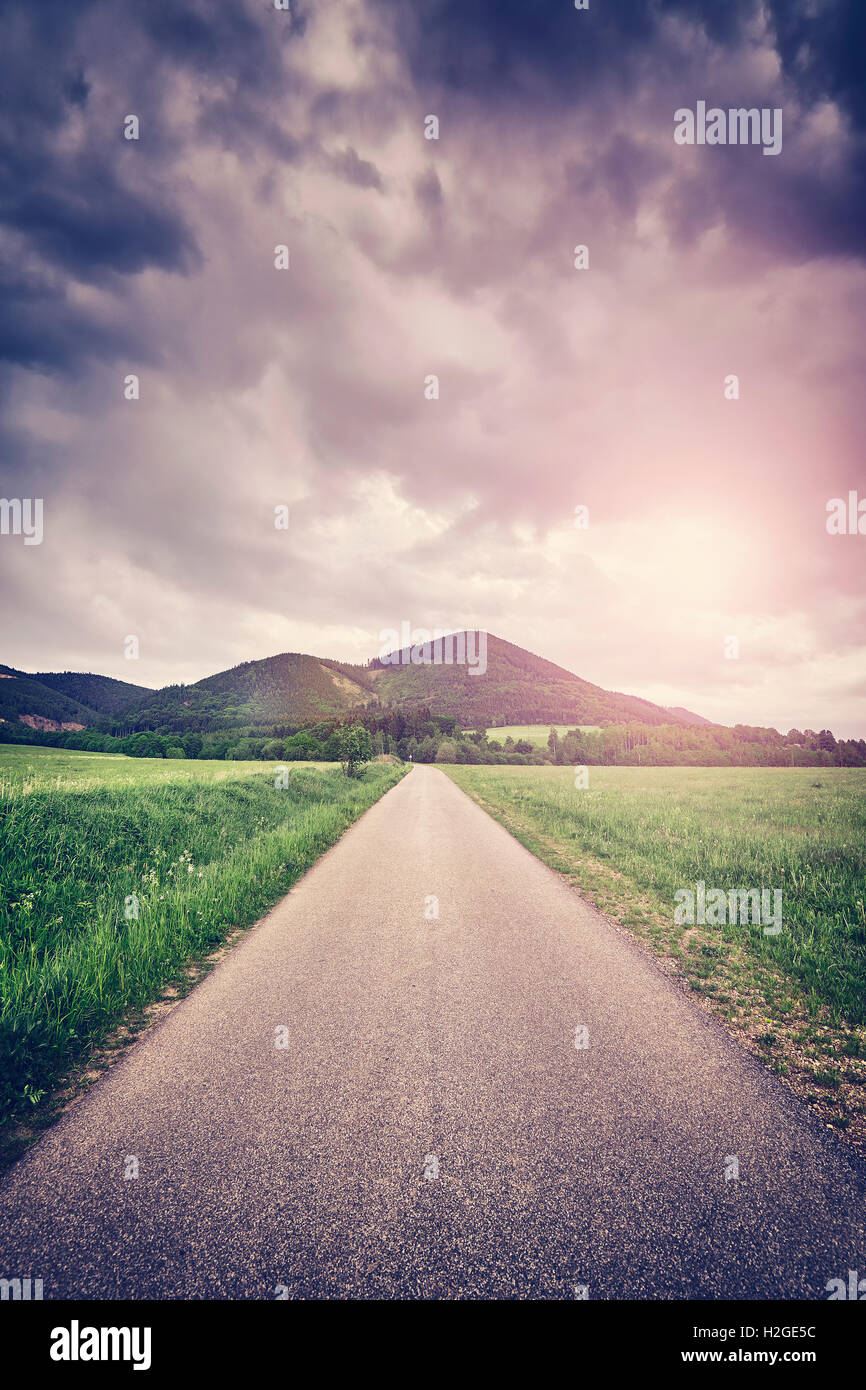Vintage toned countryside road at sunset Stock Photo - Alamy