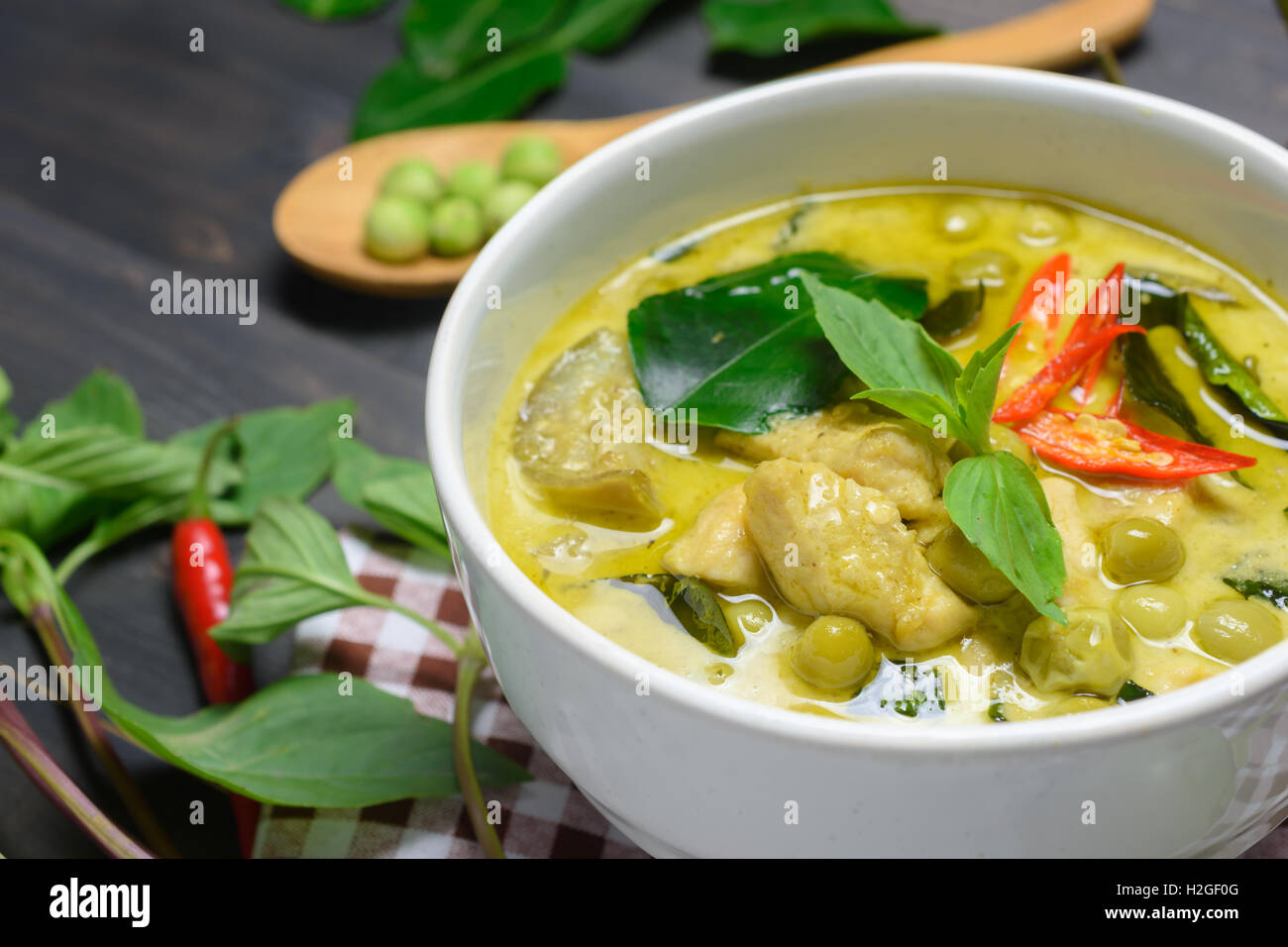 closeup green curry with chicken (Kang Keaw Wan Gai) with brown ...