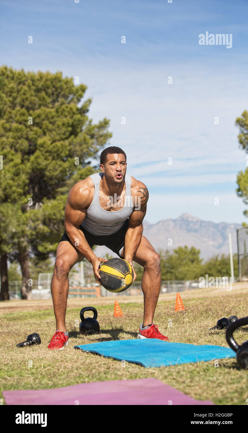 Male Exercising with Medicine Ball Stock Photo - Alamy