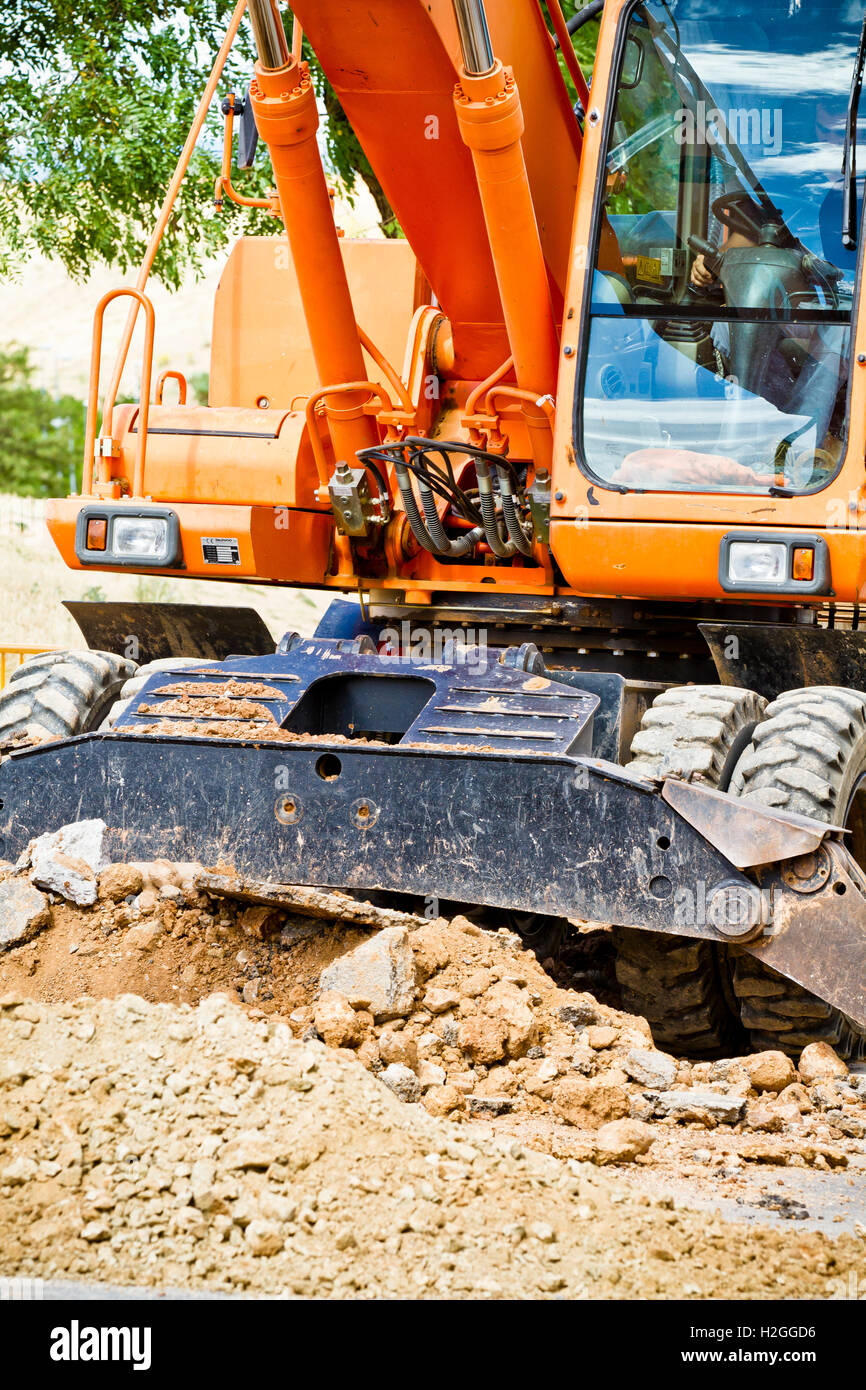 Wheel loader Excavator with backhoe unloading sand at eathmoving Stock ...