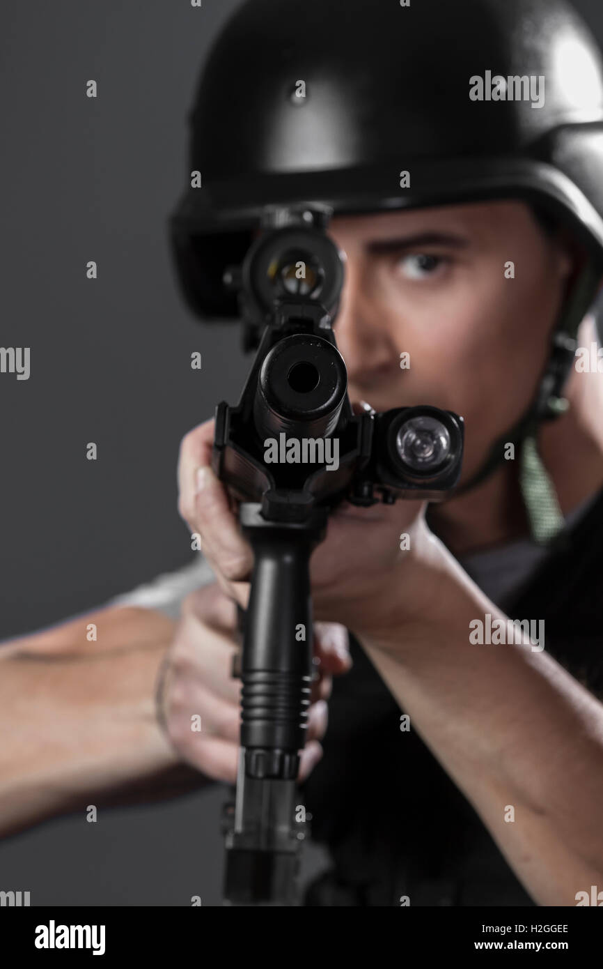 paintball sport player wearing protective helmet aiming pistol Stock ...