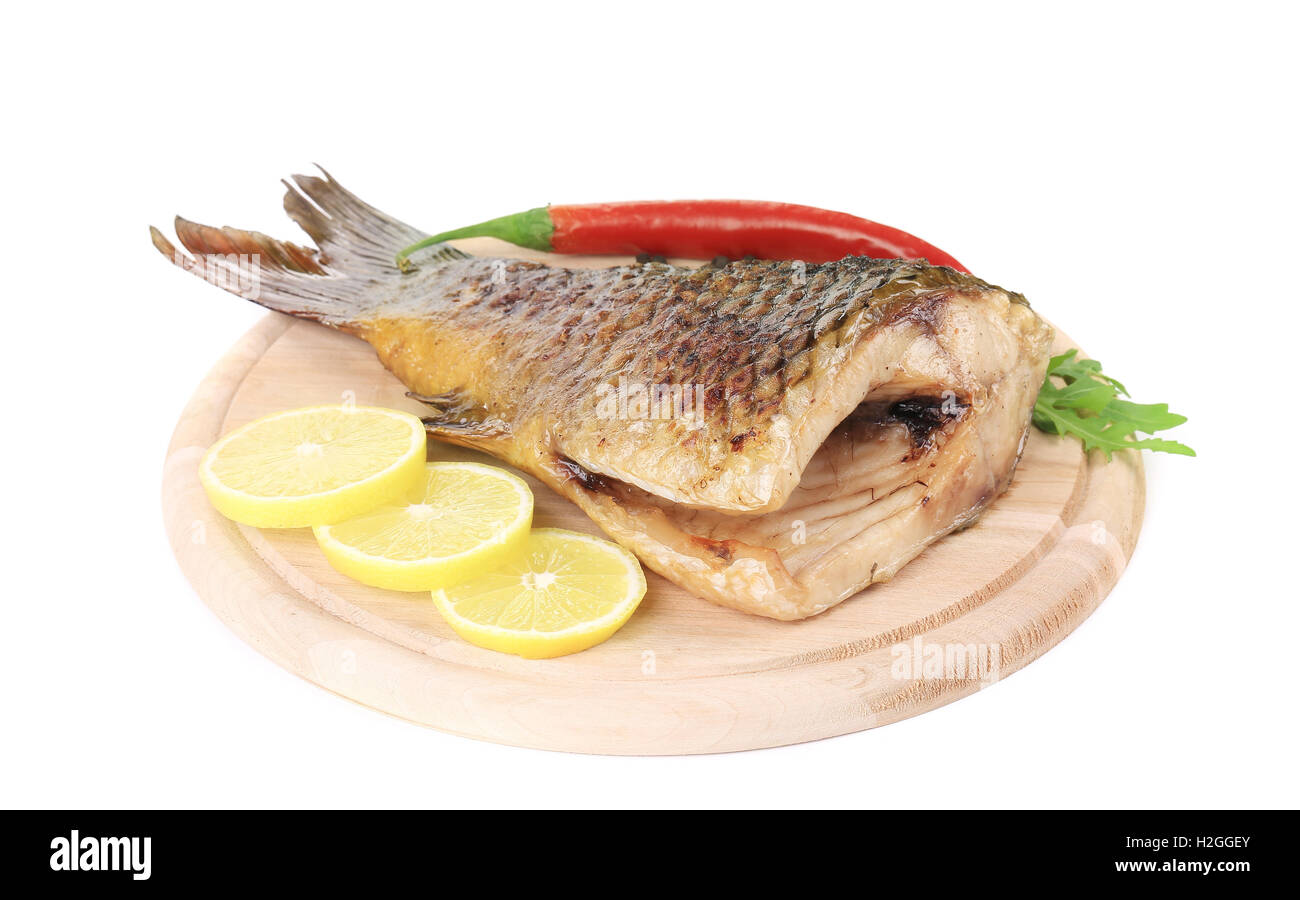 Fried fish tail on wooden table Stock Photo - Alamy