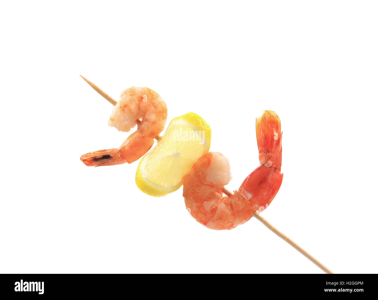 Two shrimp with lemon on a stick Stock Photo - Alamy