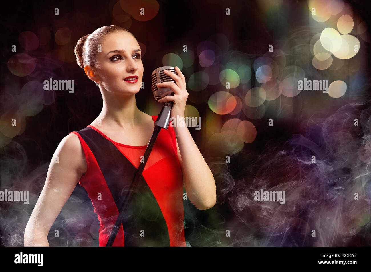 attractive female singer with microphone Stock Photo - Alamy