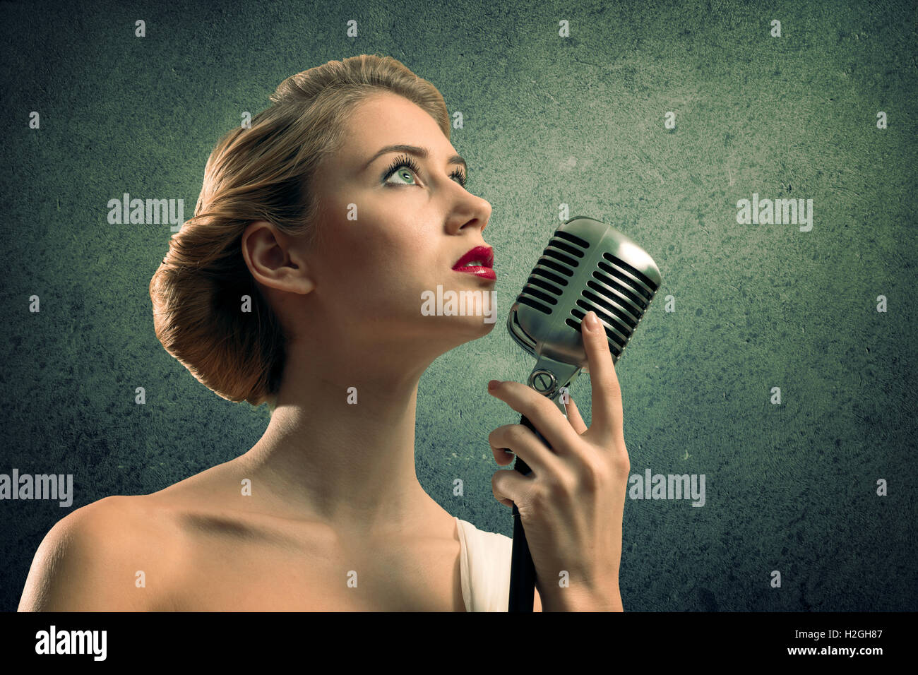 attractive female singer with microphone Stock Photo - Alamy