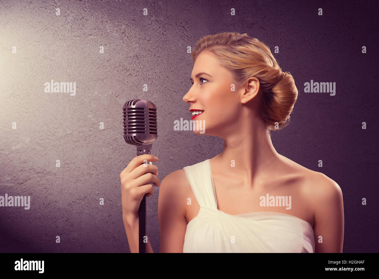 attractive female singer with microphone Stock Photo - Alamy