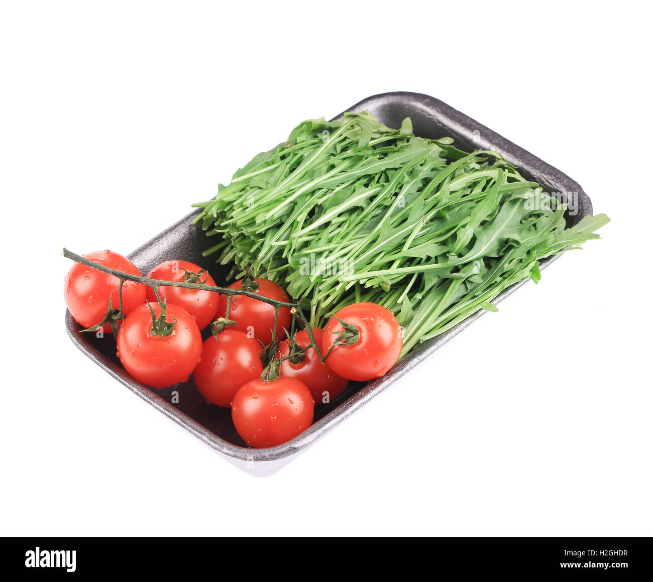 Ruccola with tomato cherry Stock Photo - Alamy