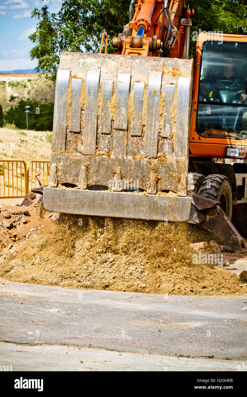 Orange coloured heavy construction digger Stock Photo - Alamy