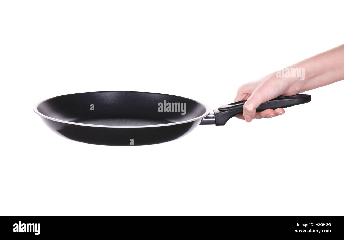 Hand holding a black frying pan Stock Photo - Alamy
