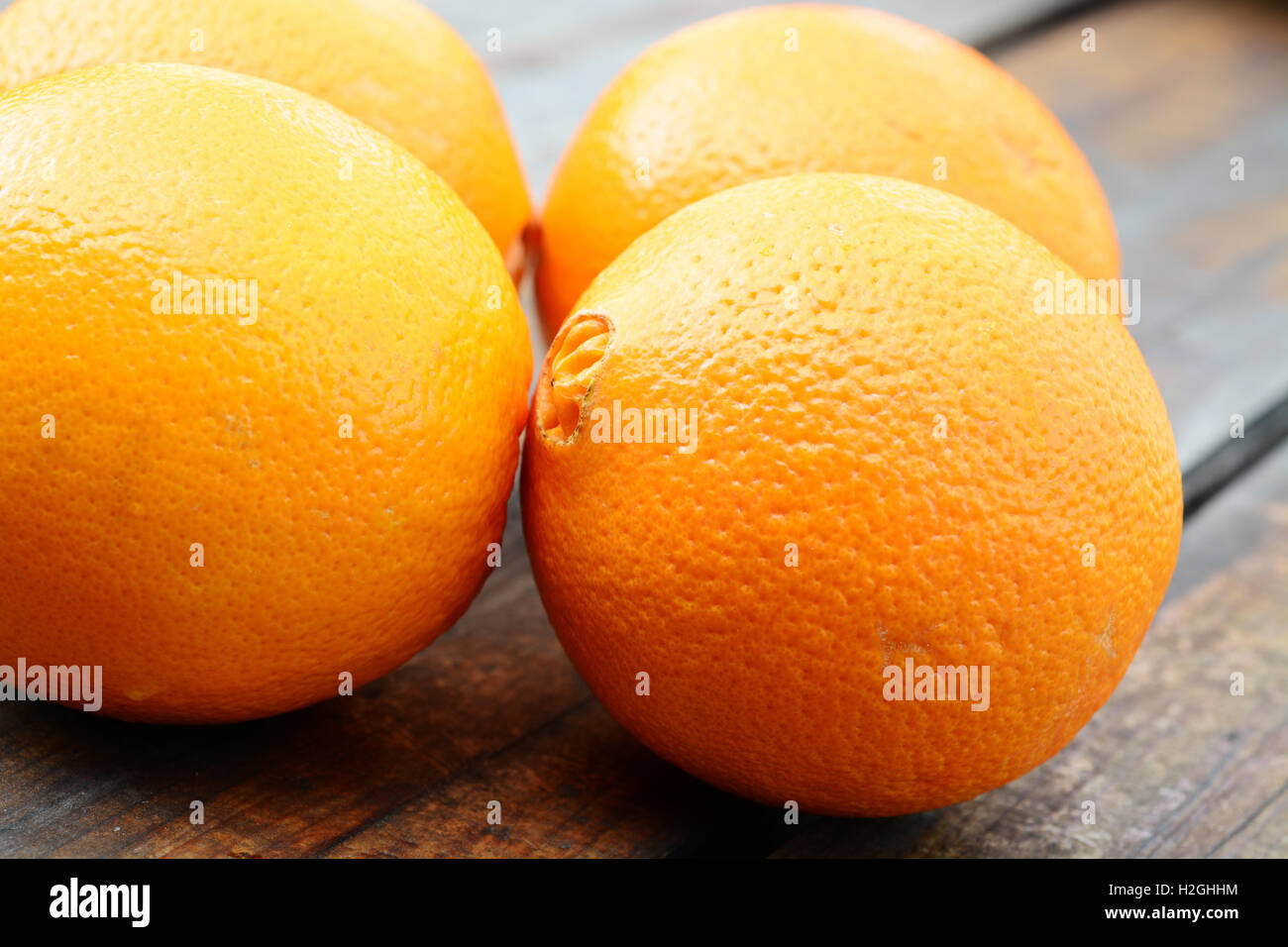 Macro shot of fresh oranges on a wooden table Stock Photo - Alamy
