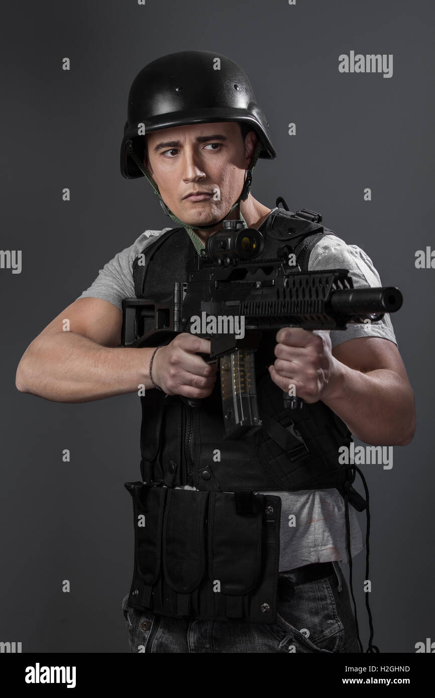 Soldier, paintball sport player wearing protective helmet aiming Stock ...