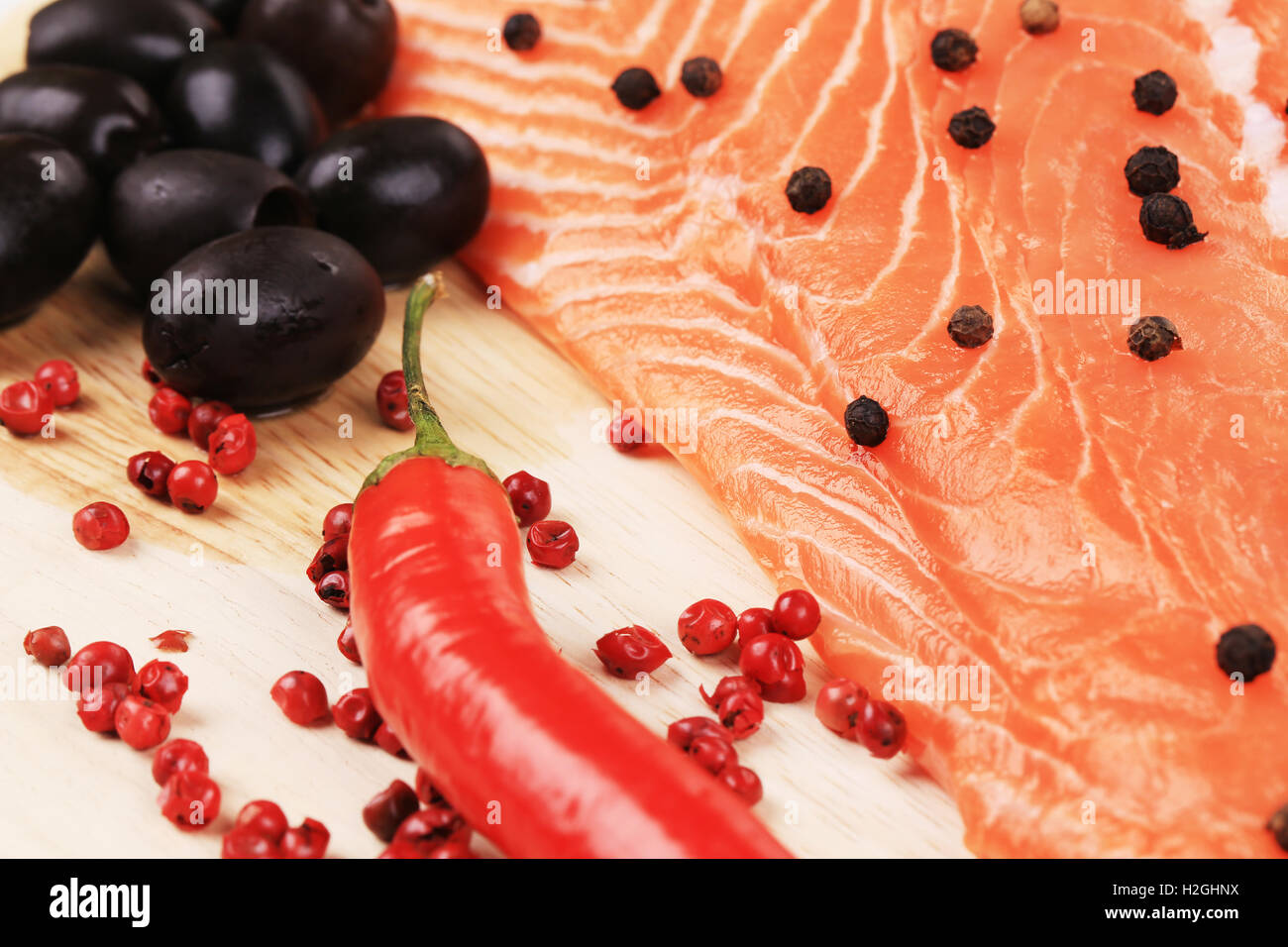 Salmon fillet with olives and red pepper Stock Photo - Alamy