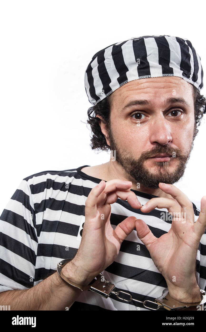 Desperate, portrait of a man prisoner in prison garb, over white Stock ...
