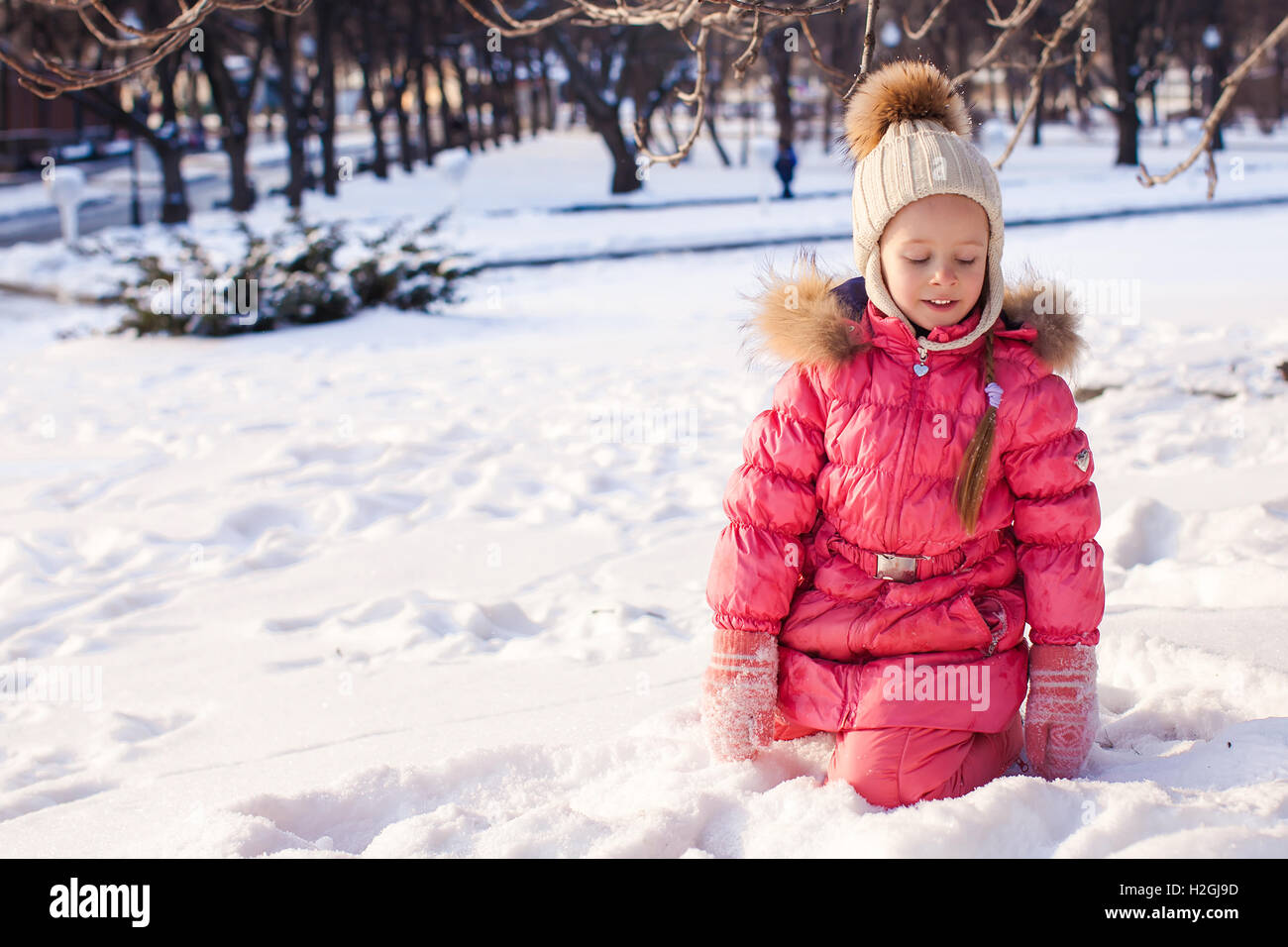 Adorable little girl have fun outdoor on cold winter day Stock Photo ...