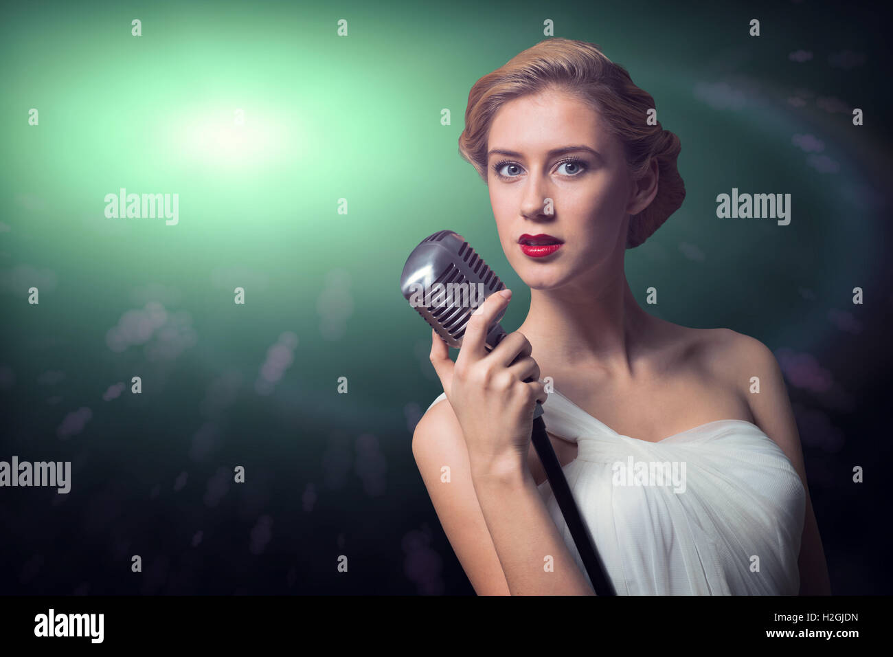 attractive female singer with microphone Stock Photo - Alamy