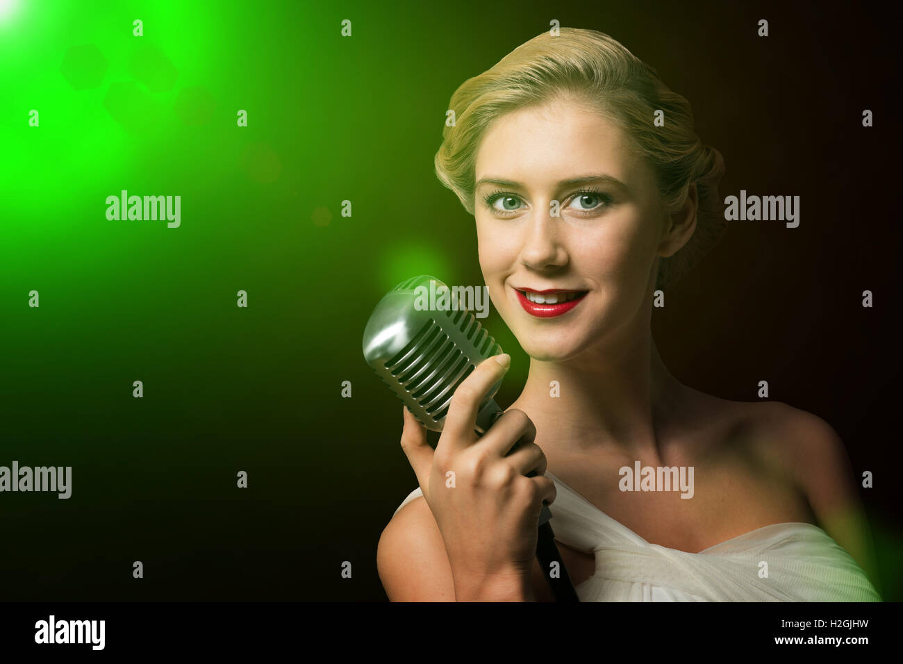 attractive female singer with microphone Stock Photo - Alamy