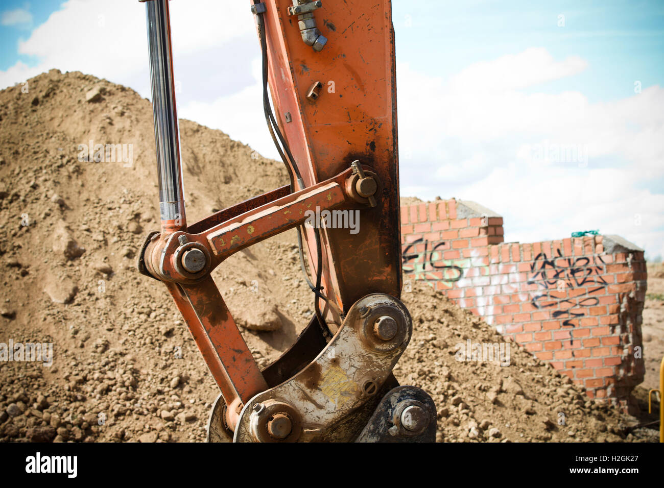 Excavator standing in sandpit with raised bucket over cloudscape Stock ...