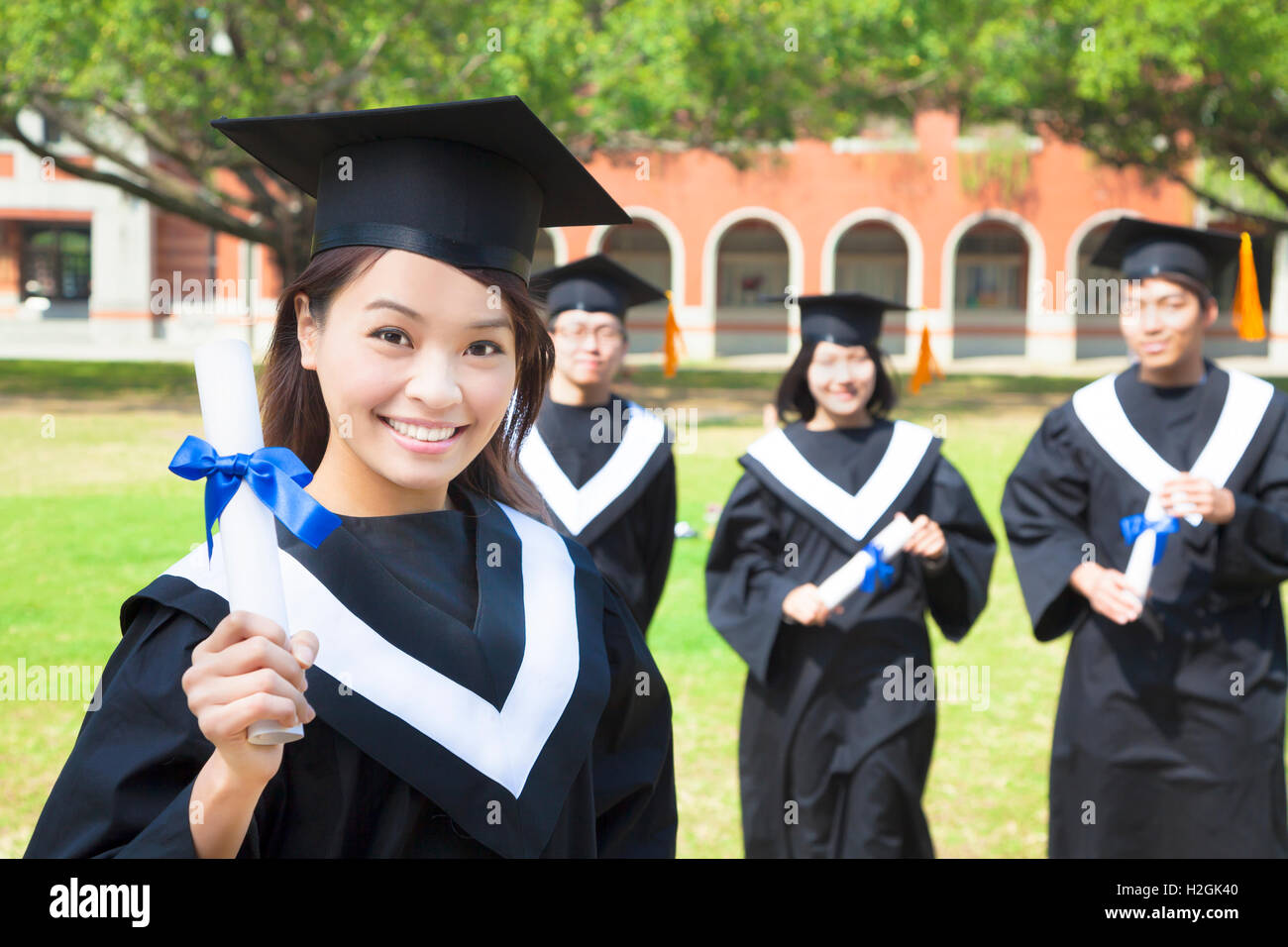 smiling college graduate show a diploma Stock Photo - Alamy