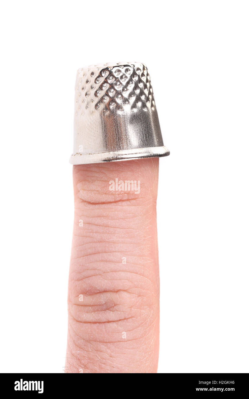 Metal sewing thimble on finger Stock Photo - Alamy