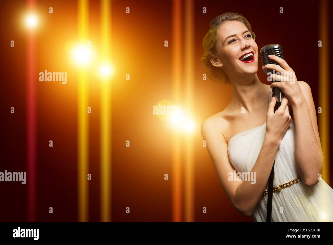 attractive female singer with microphone Stock Photo - Alamy