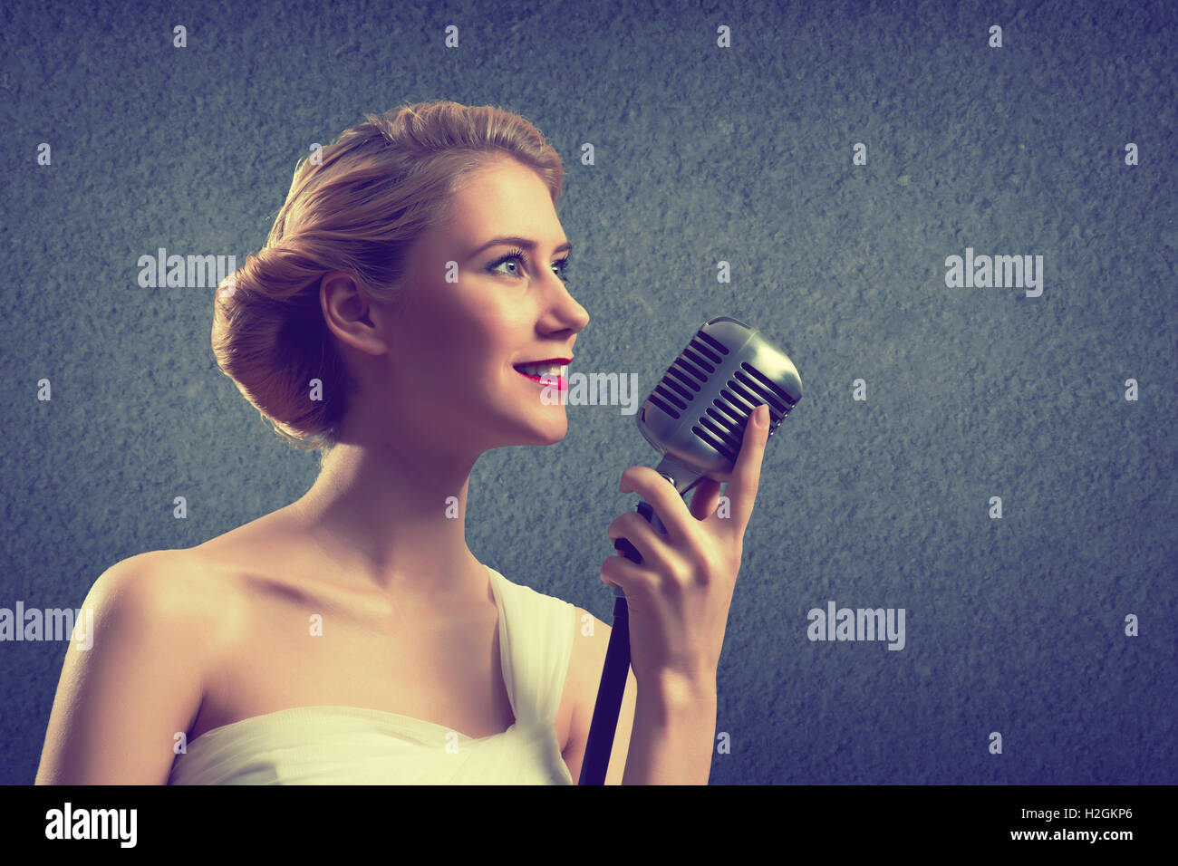 attractive female singer with microphone Stock Photo - Alamy