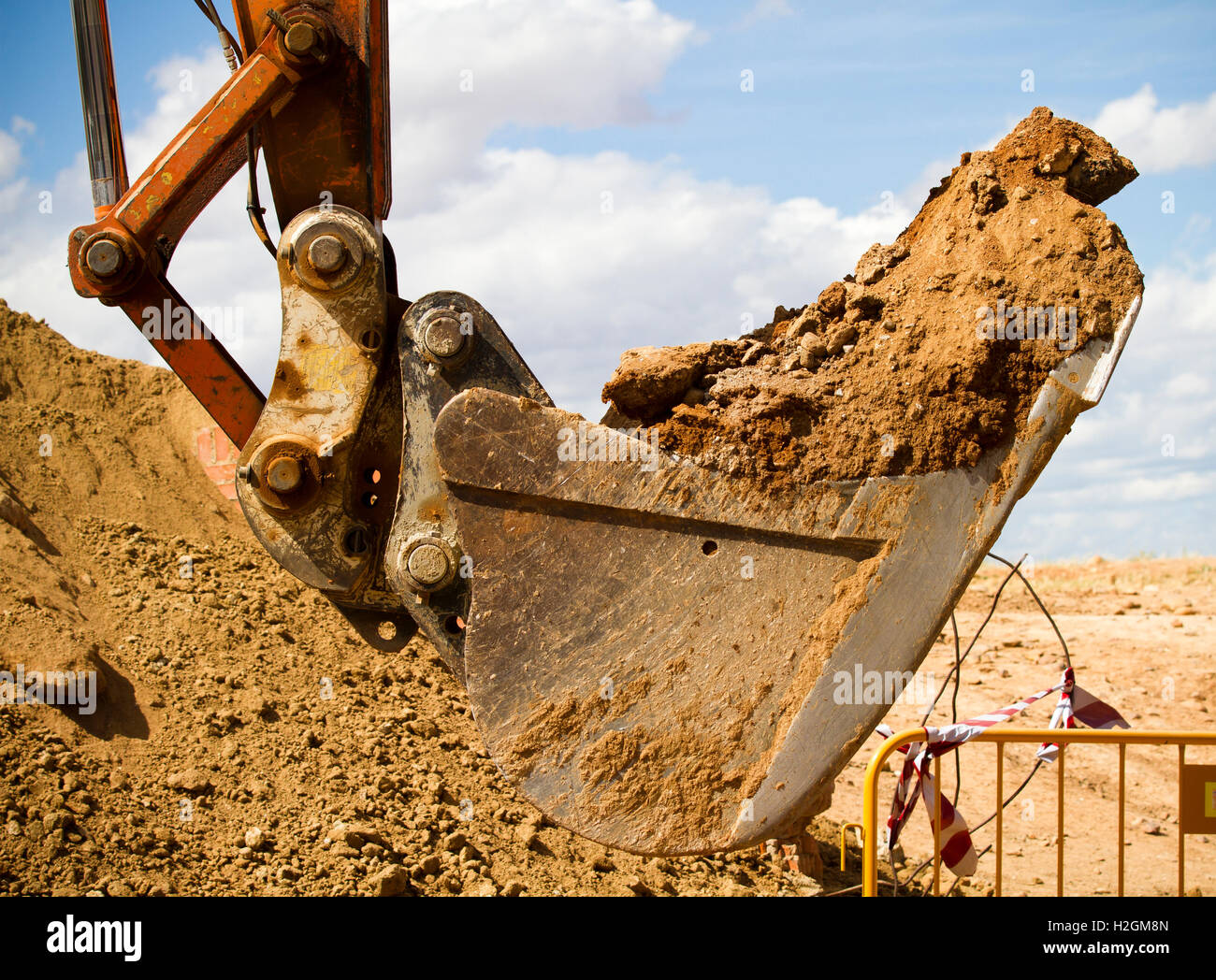 Excavator digging a deep trench, working, sand Stock Photo - Alamy