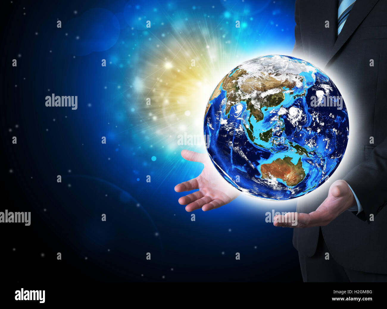 Man in suit holding a earth in hand Stock Photo - Alamy