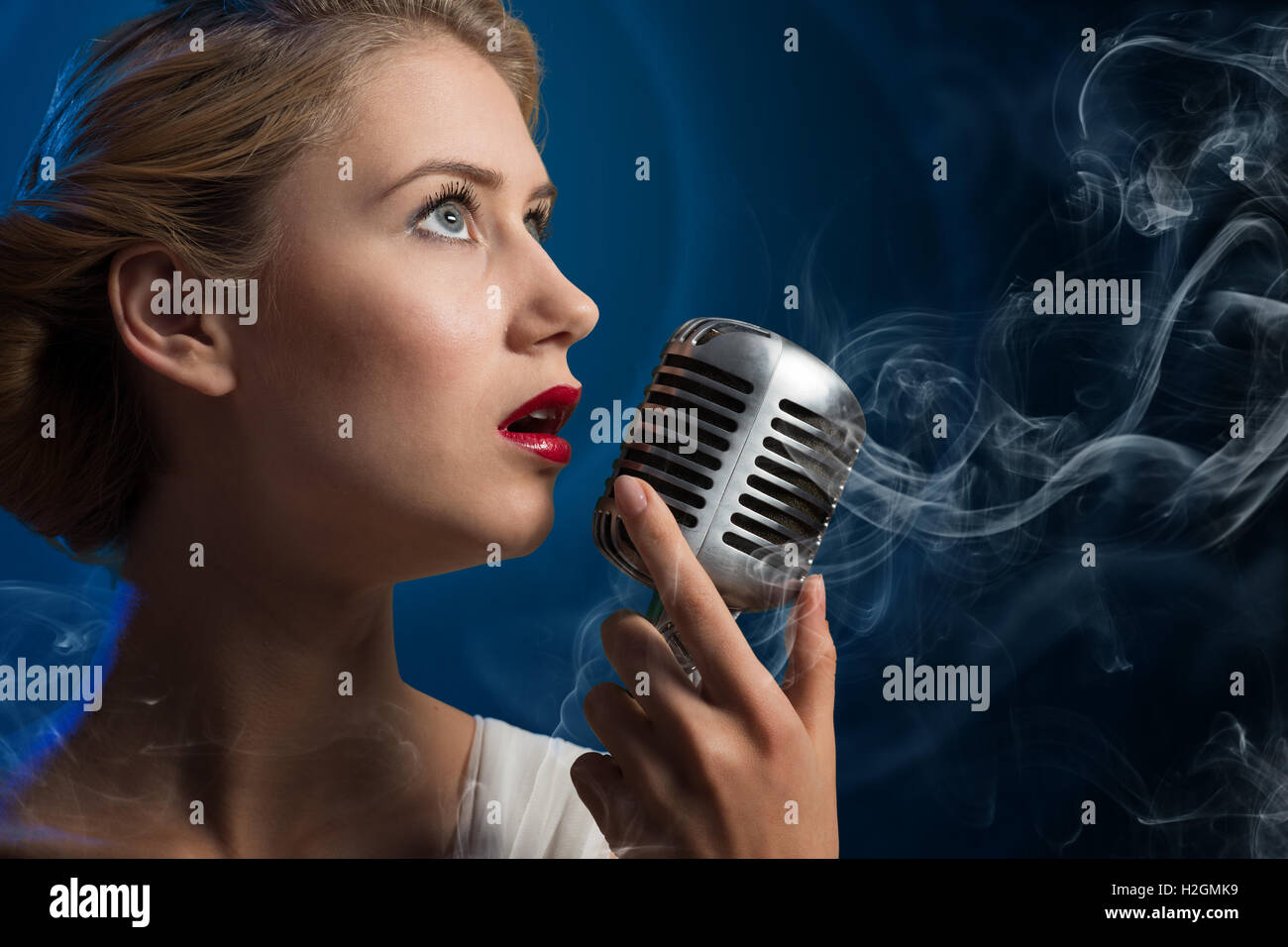 attractive female singer with microphone Stock Photo - Alamy