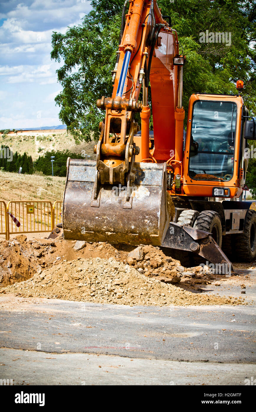 Wheel loader Excavator with backhoe unloading sand at eathmoving Stock ...