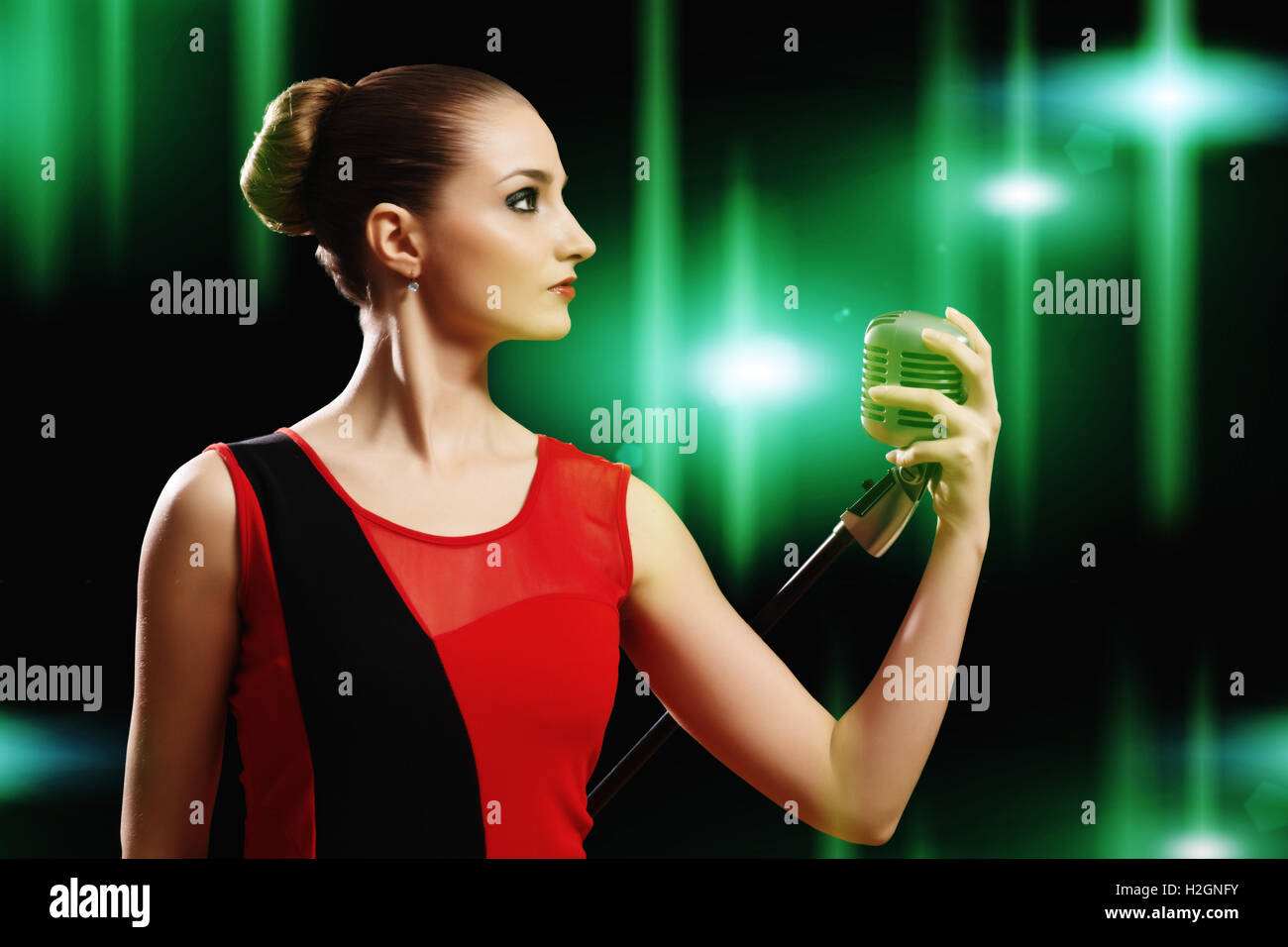 attractive female singer with microphone Stock Photo - Alamy